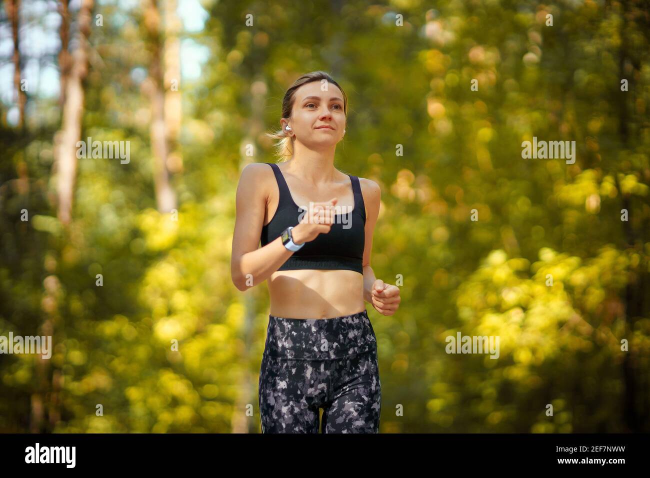Pretty young girl runner in the forest Stock Photo - Alamy