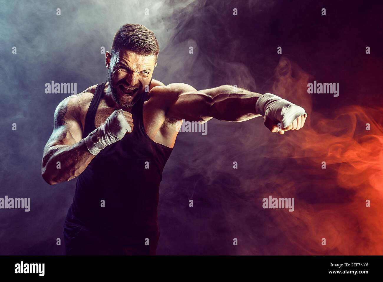 Sportsman boxer fighting on black background with shadow. Copy Space ...