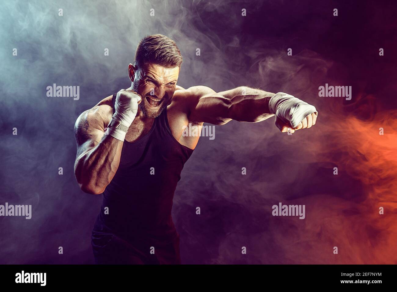 Sportsman boxer fighting on black background with shadow. Copy Space ...