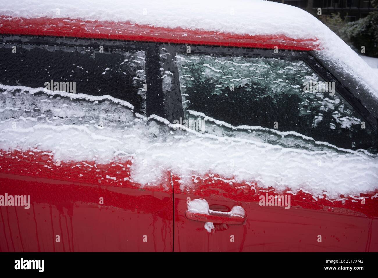Frozen red car on the streets after snow and freezing rain Stock Photo ...