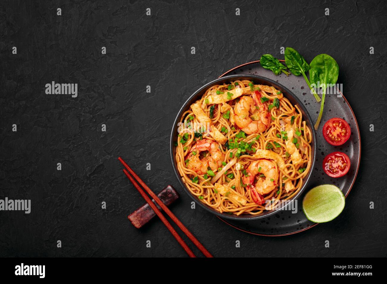 Mie Goreng in black bowl on dark slate table top. Indonesian cuisine ...