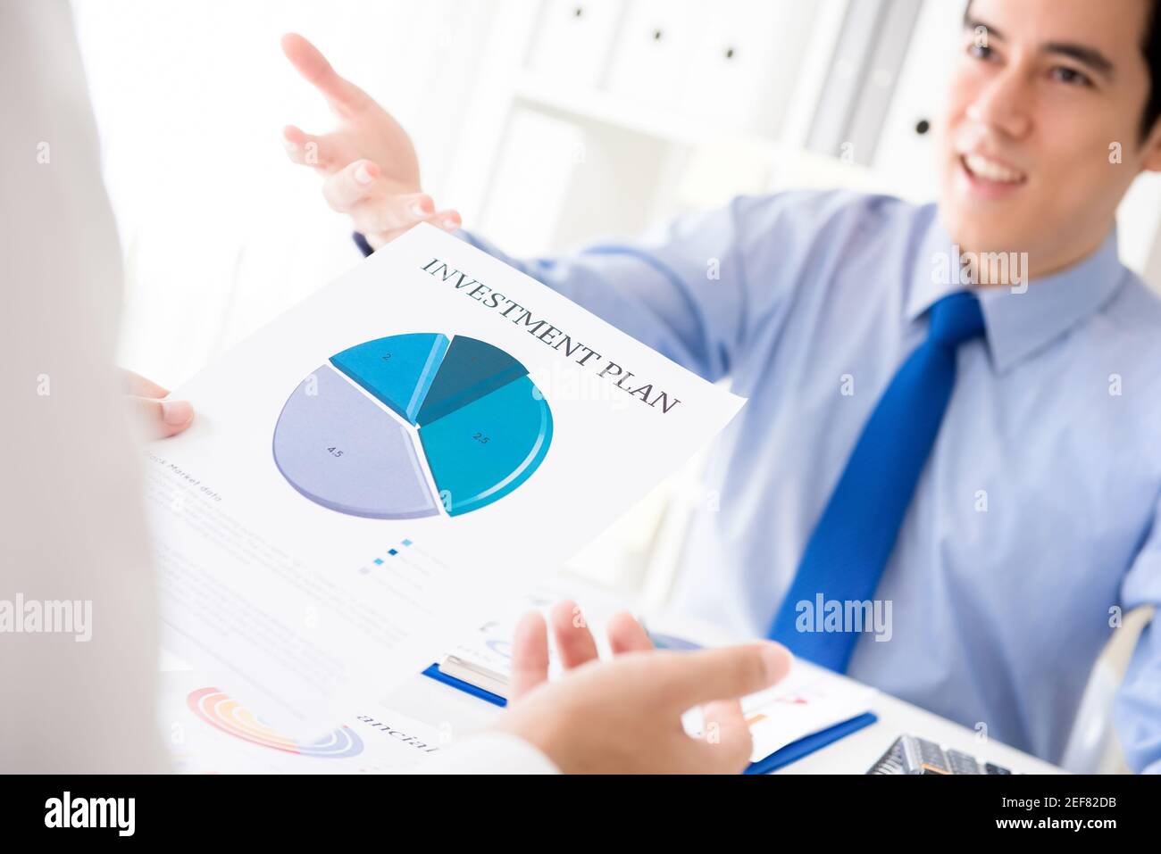 Business people discussing investment plan chart document in the ...