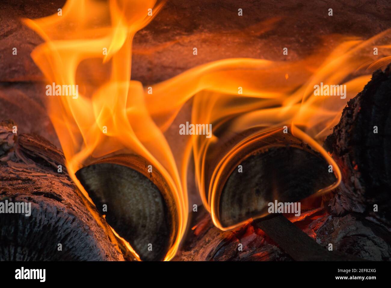 Wooden logs burning in a home fireplace Stock Photo - Alamy