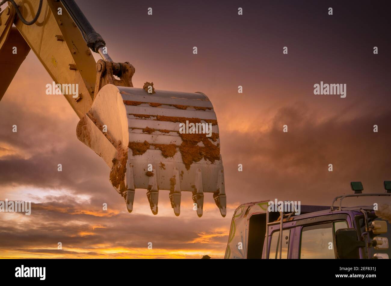 Dirt metal bucket of backhoe after digging soil. Backhoe parked near ...