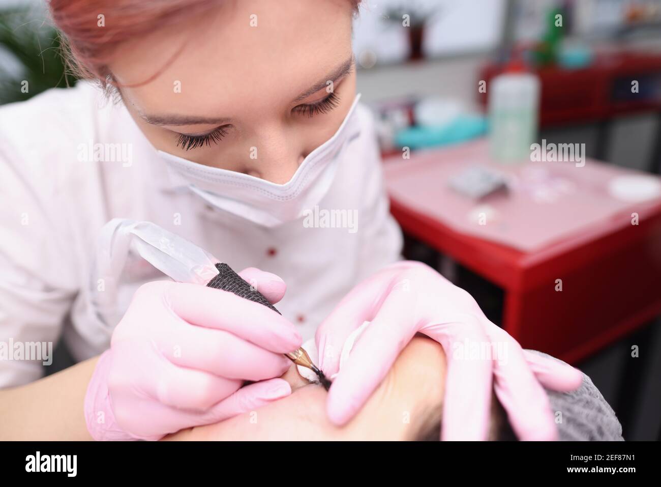 Master cosmetologist makes permanent eyelid tattoo in beauty salon ...