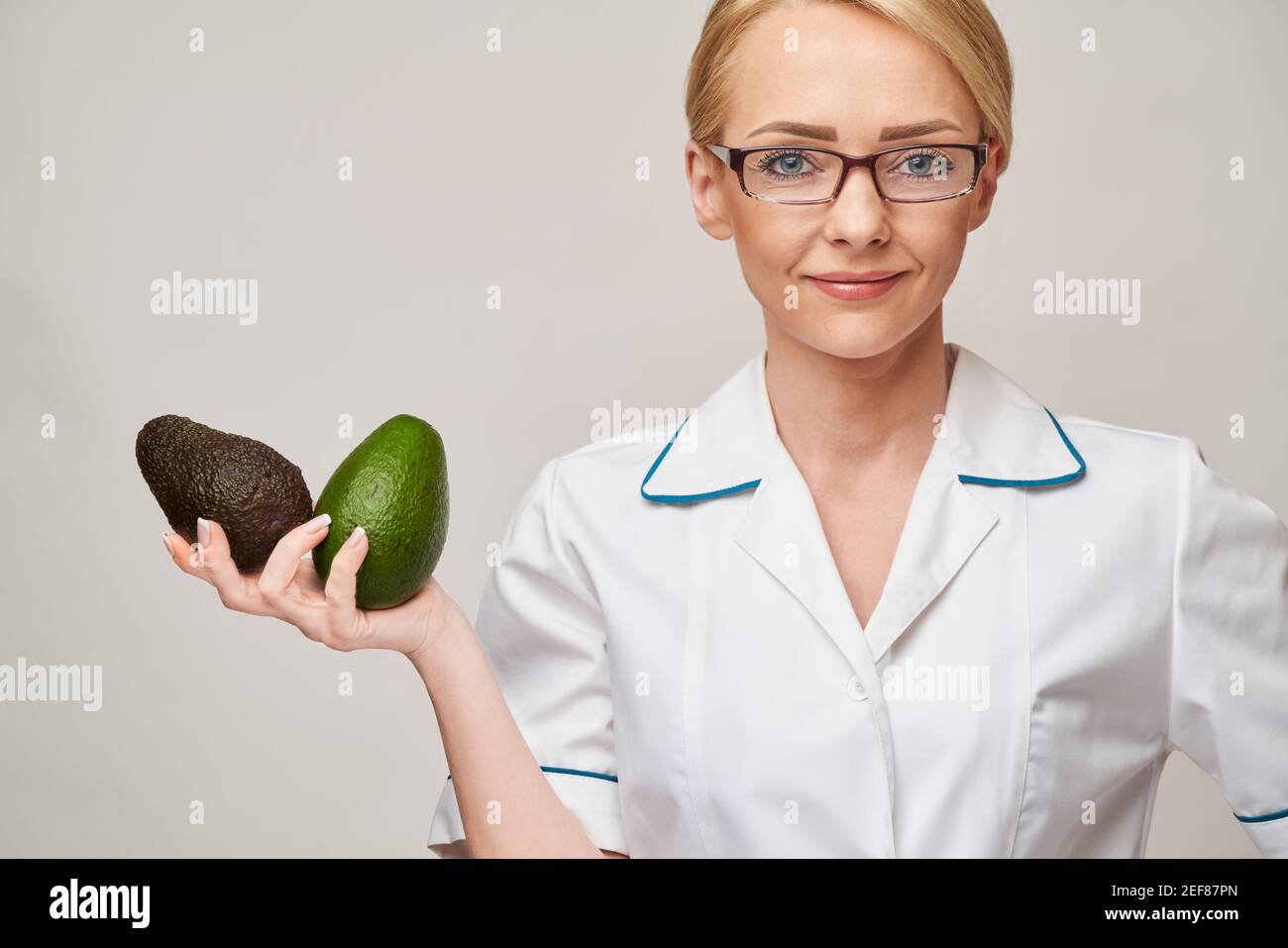 nutritionist doctor healthy lifestyle concept - holding organic avocado ...