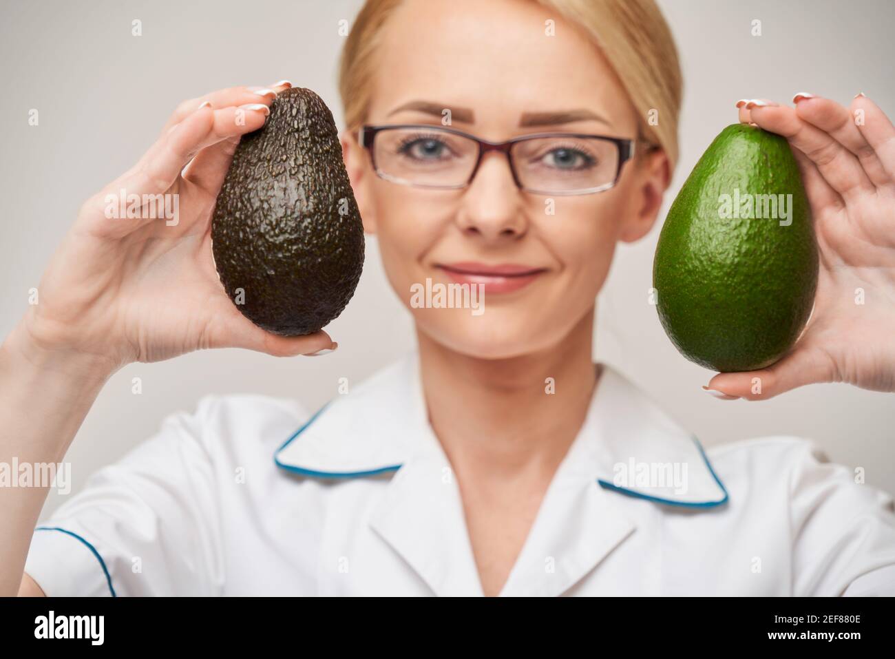nutritionist doctor healthy lifestyle concept - holding organic avocado ...