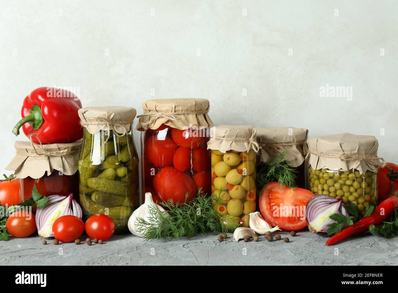 Different canned food and ingredients on gray table Stock Photo - Alamy