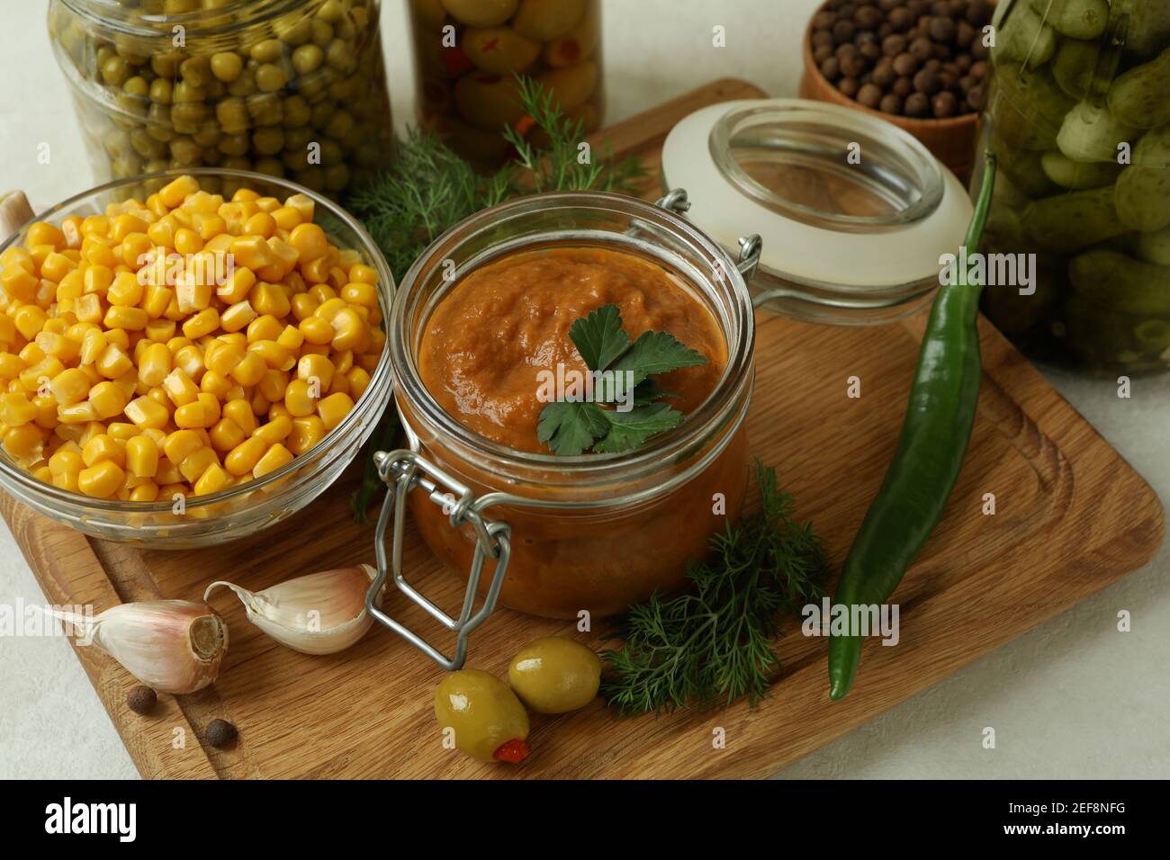 Different pickled food and ingredients on white textured table Stock ...