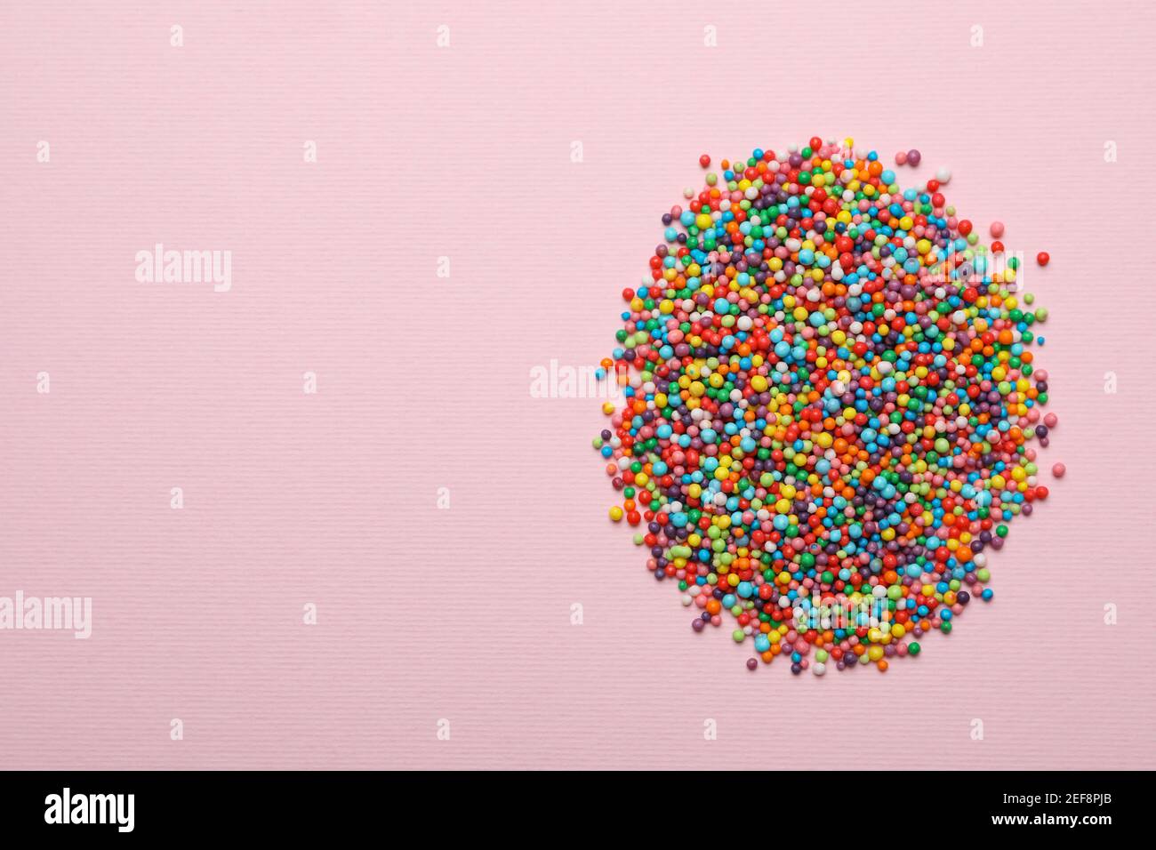 Egg made of sprinkles on pink background Stock Photo - Alamy