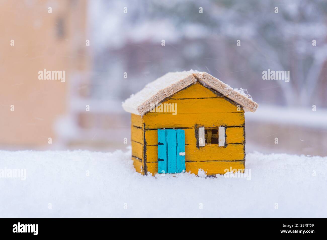 colored wooden model house in snow Stock Photo - Alamy