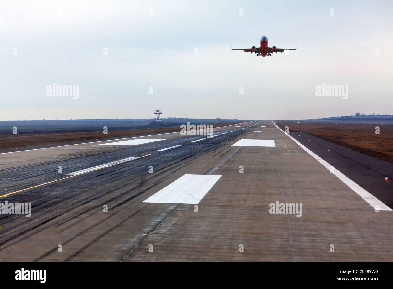 Plane is landing . Airplane over the runway strip Stock Photo - Alamy