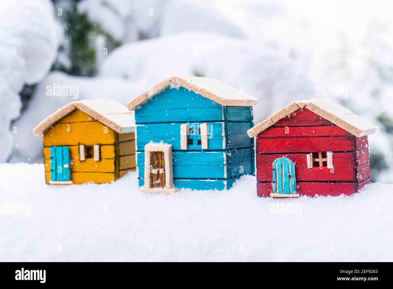 colorful wooden model homes in the snow Stock Photo - Alamy