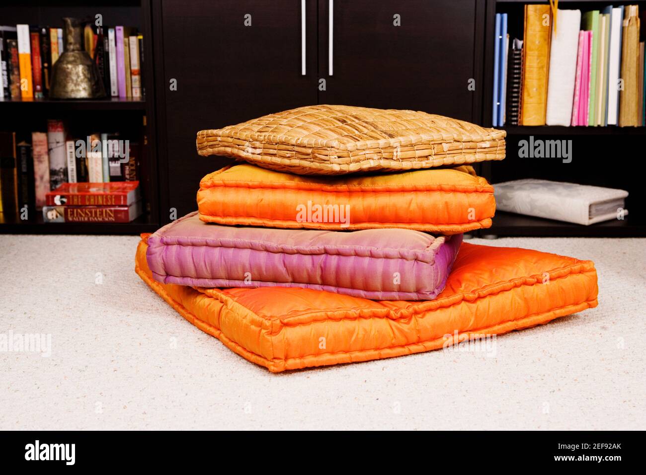 Stack of cushions in front of a cabinet Stock Photo - Alamy