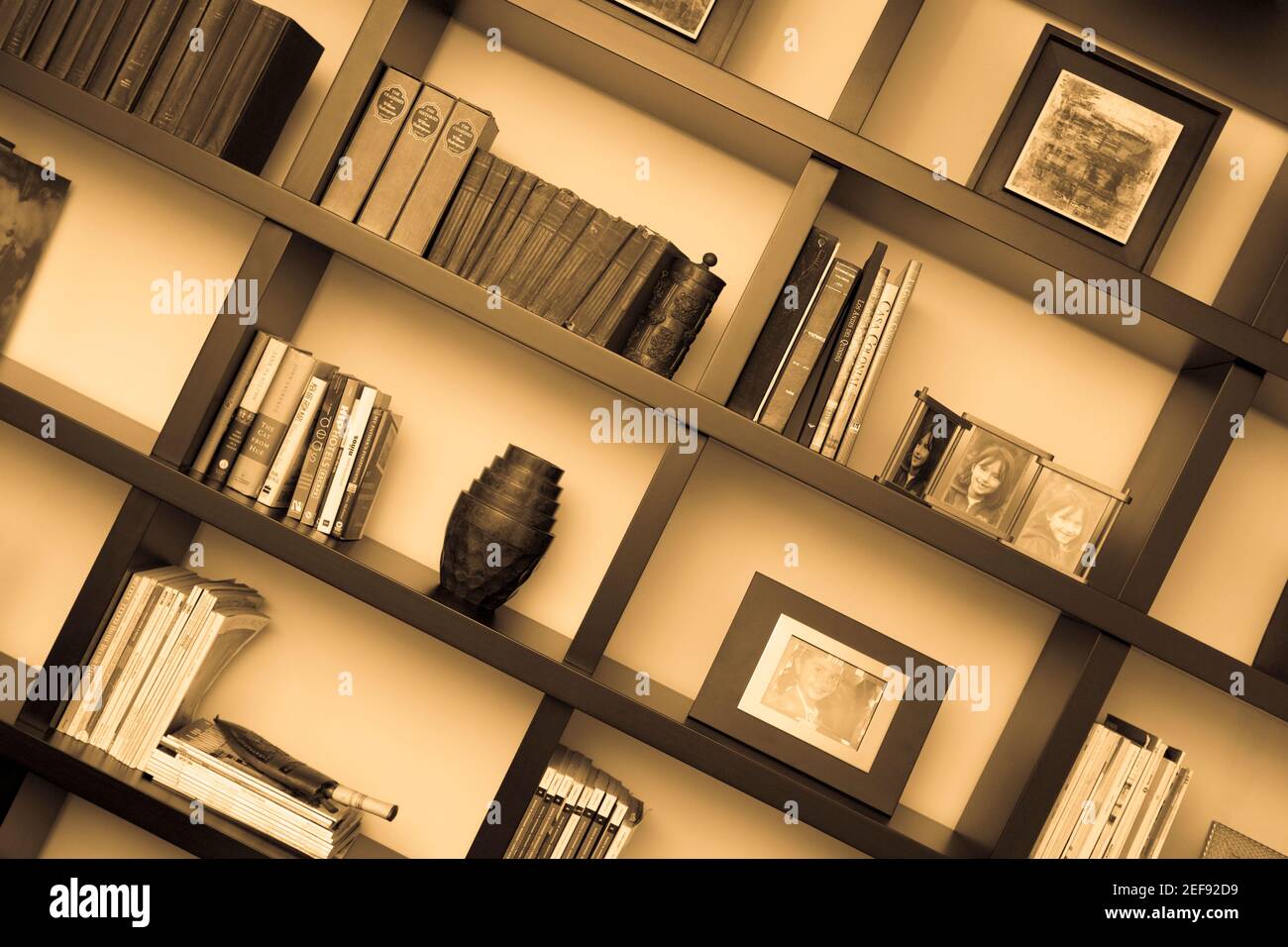 Books and picture frames in shelves Stock Photo - Alamy