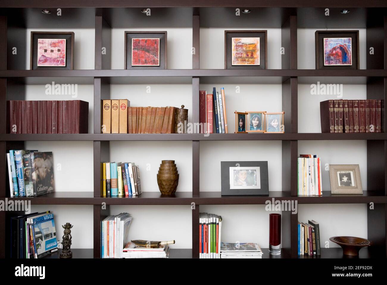 Books and picture frames in shelves Stock Photo - Alamy
