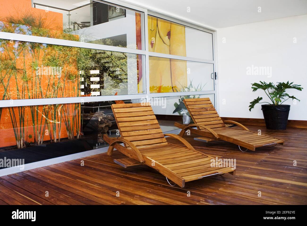 Two lounge chairs in a patio of a house Stock Photo - Alamy