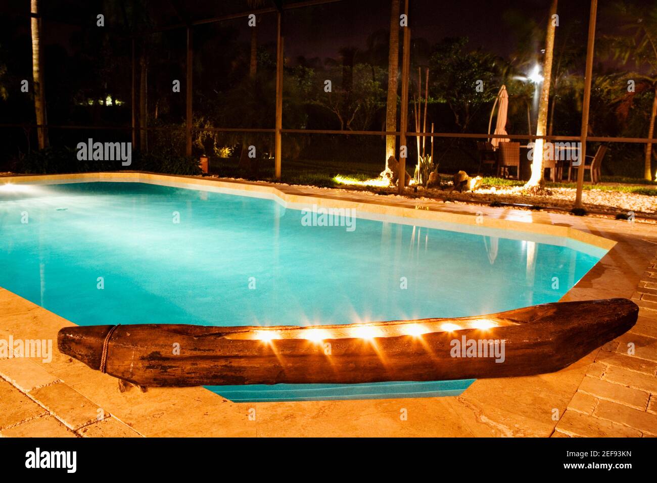 Swimming pool lit up at night Stock Photo - Alamy