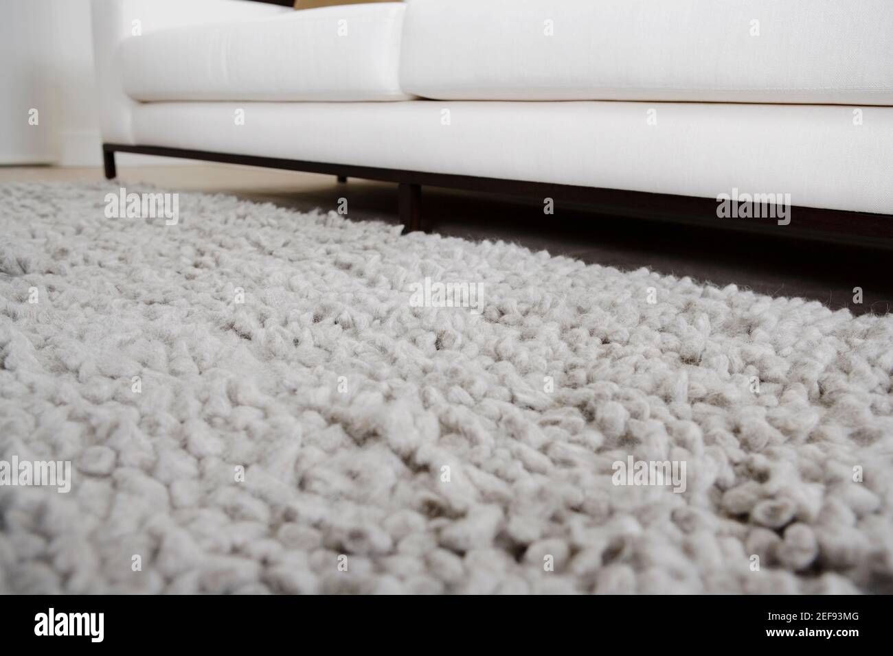 Carpet and a couch in a living room Stock Photo - Alamy