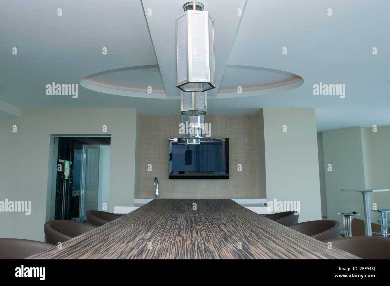 Lamp shades hanging over a table in a hotel Stock Photo - Alamy