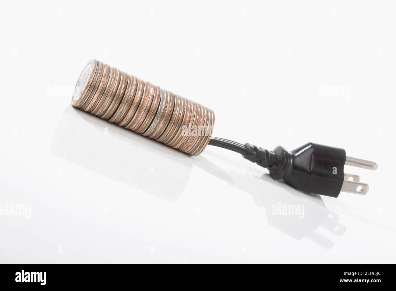 Stack of coins with a three pin plug Stock Photo - Alamy
