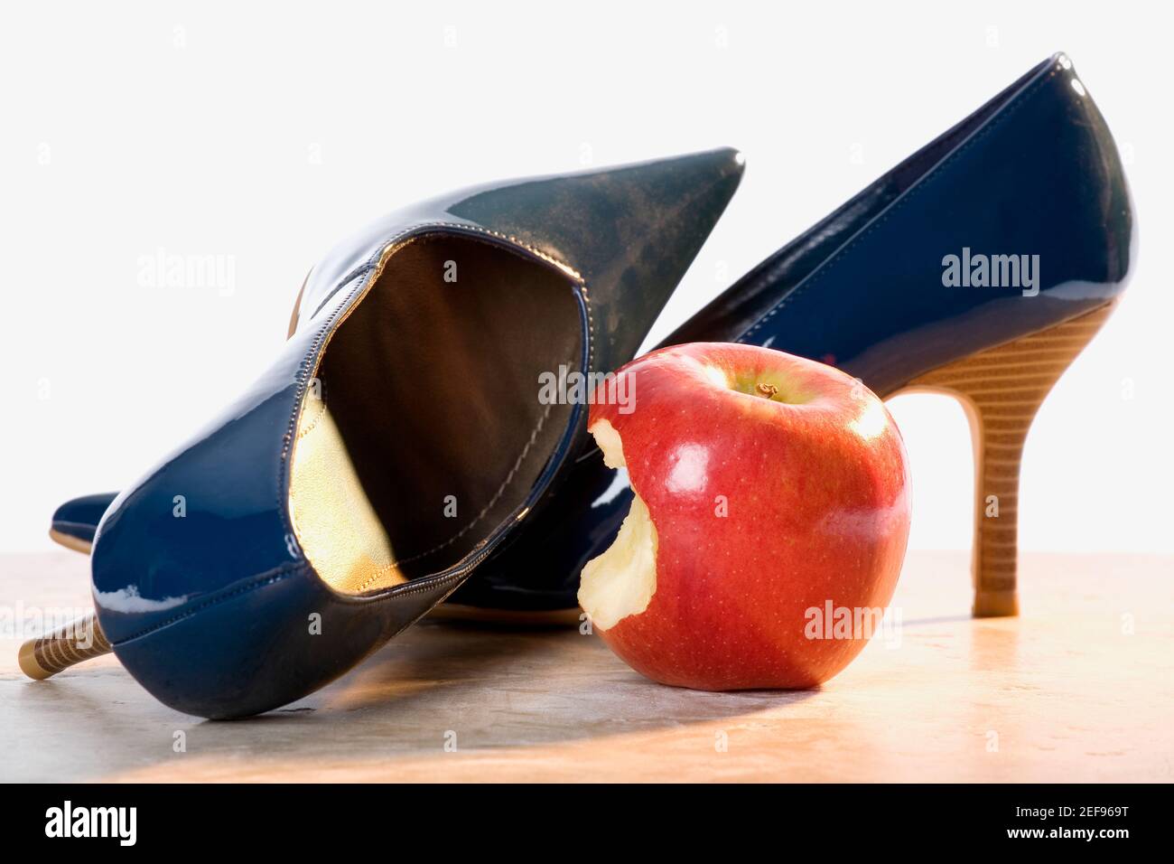 Close-up of a pair of high heels and an apple with a missing bite Stock ...
