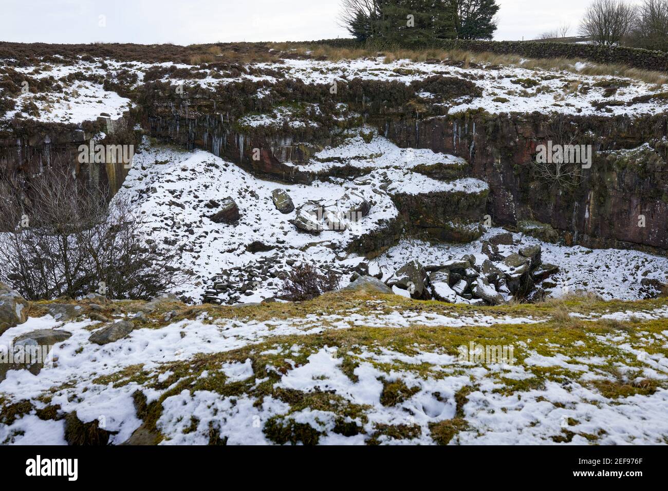 Icicles hang on the shear face of this disused moorland quarry Stock ...