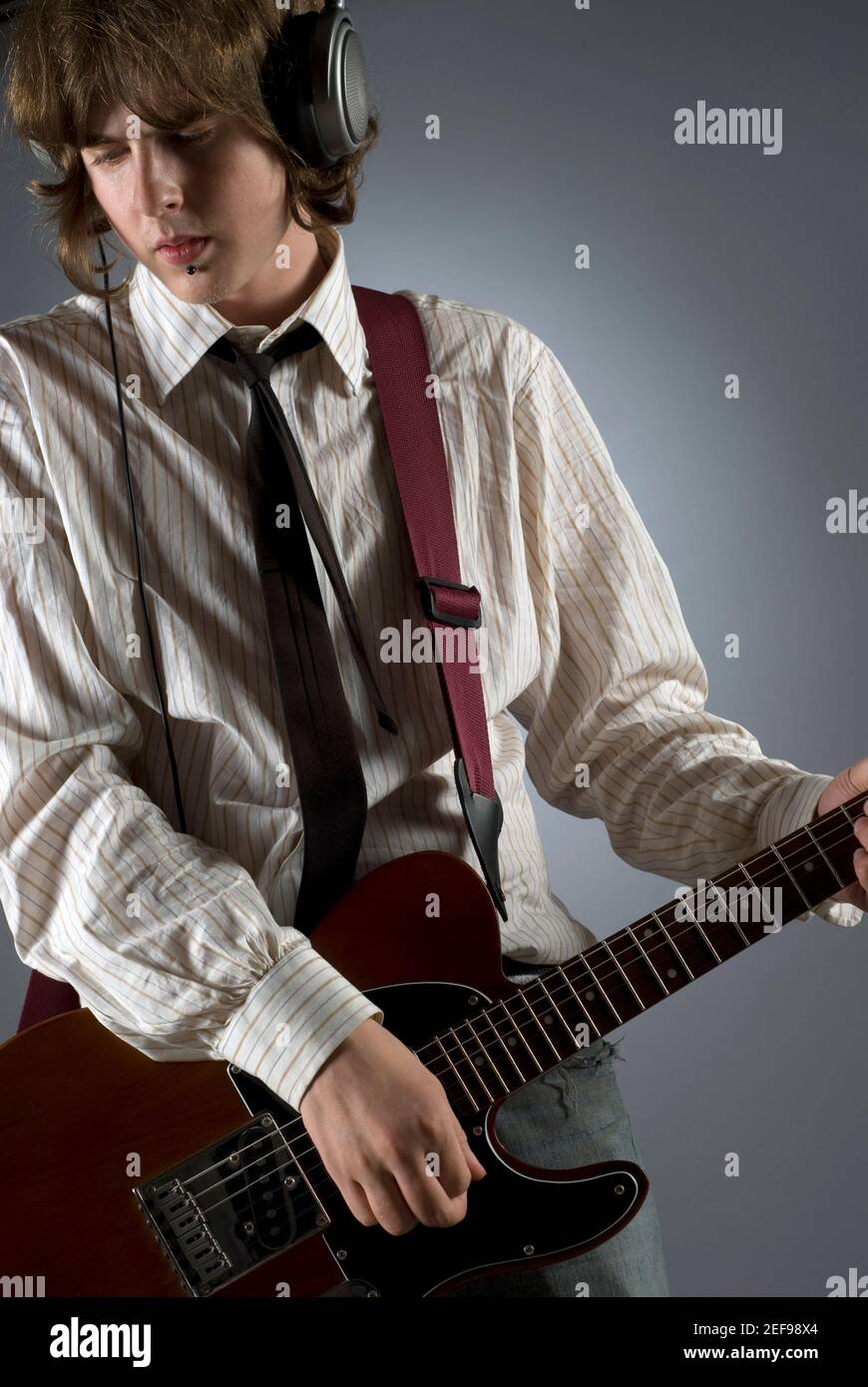 Close-up of a guitarist playing a guitar Stock Photo - Alamy