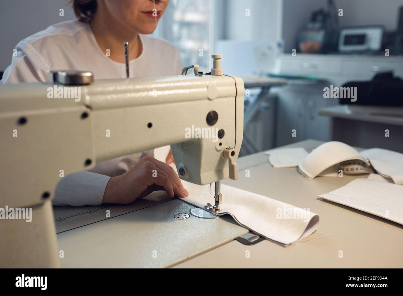 young girl seamstress while working on tailoring in her workshop Stock ...
