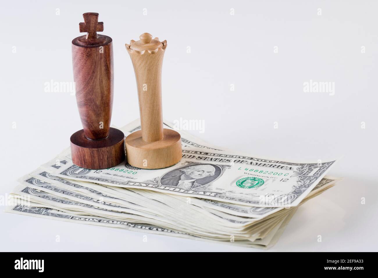 Chess pieces on stack of US paper currency Stock Photo - Alamy
