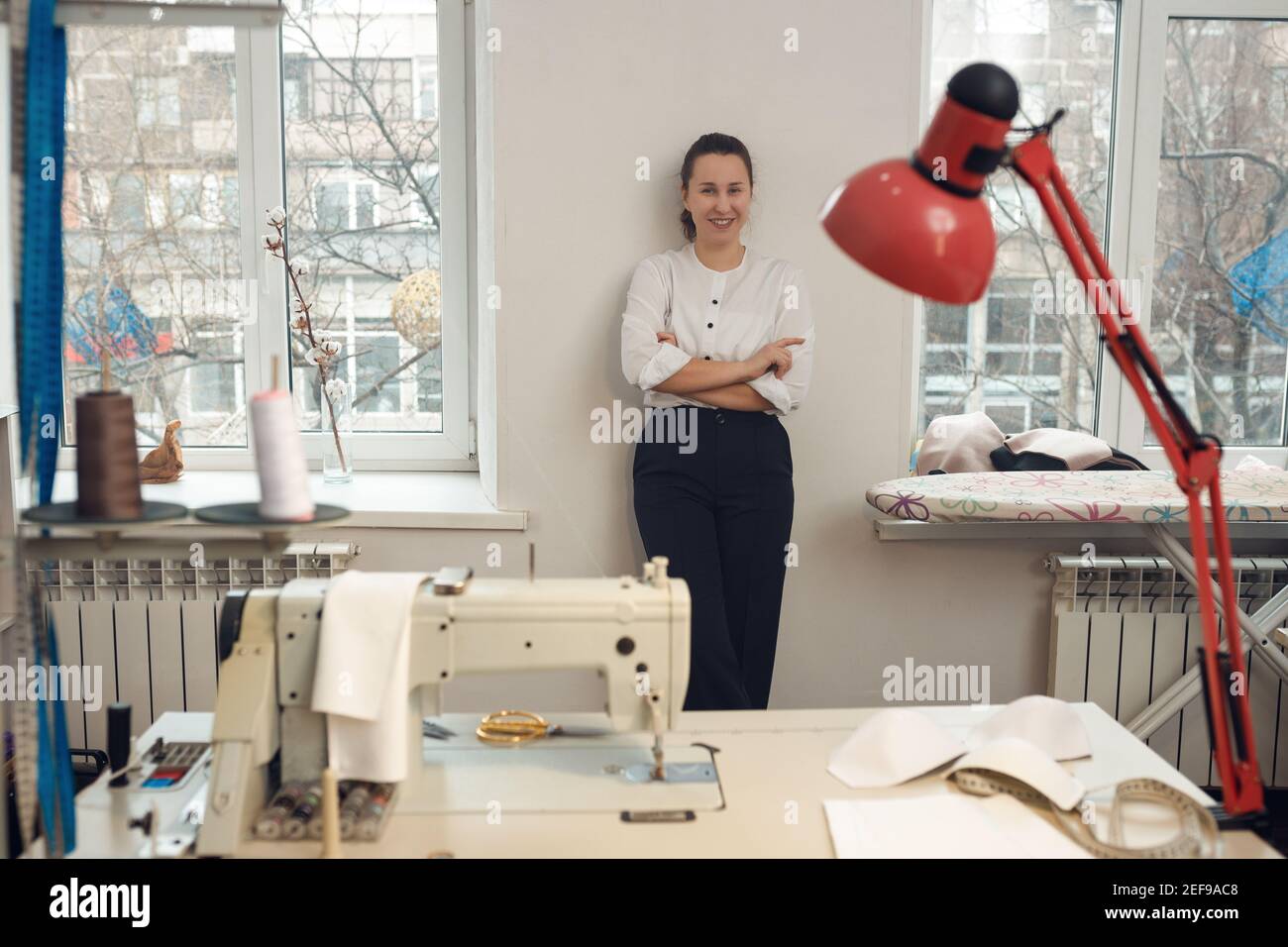 young girl seamstress posing in front of her tailoring workshop Stock ...