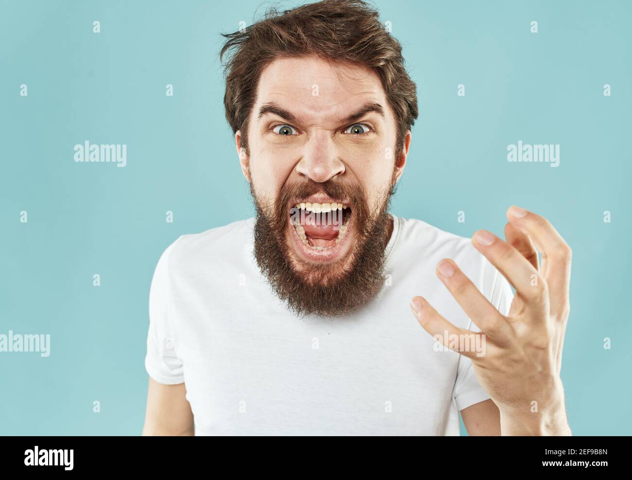 aggressive man yelling on blue background stress irritability emotions ...