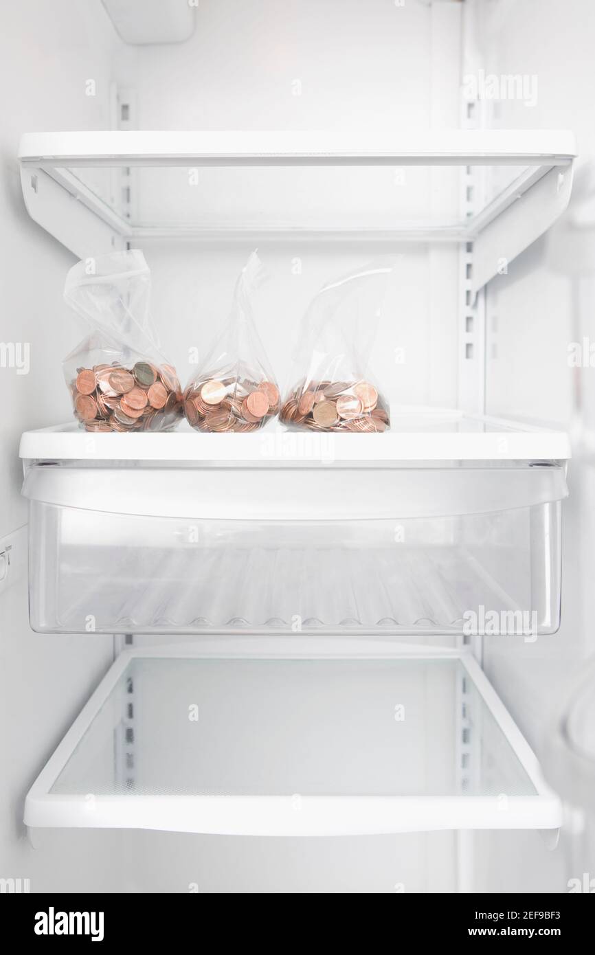 Three plastic bags of coins in a refrigerator Stock Photo - Alamy