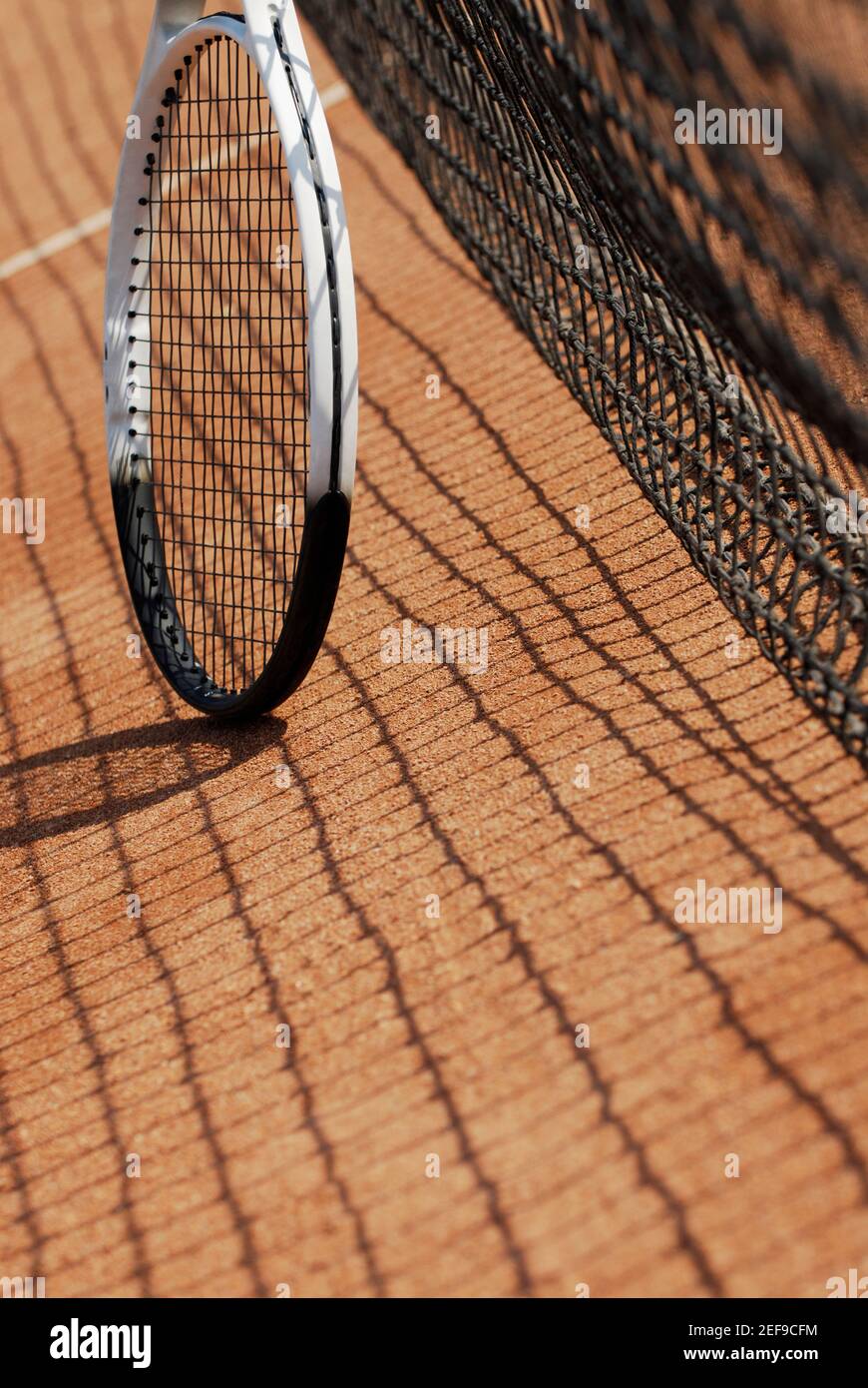 Tennis racket near a tennis net on a tennis court Stock Photo - Alamy