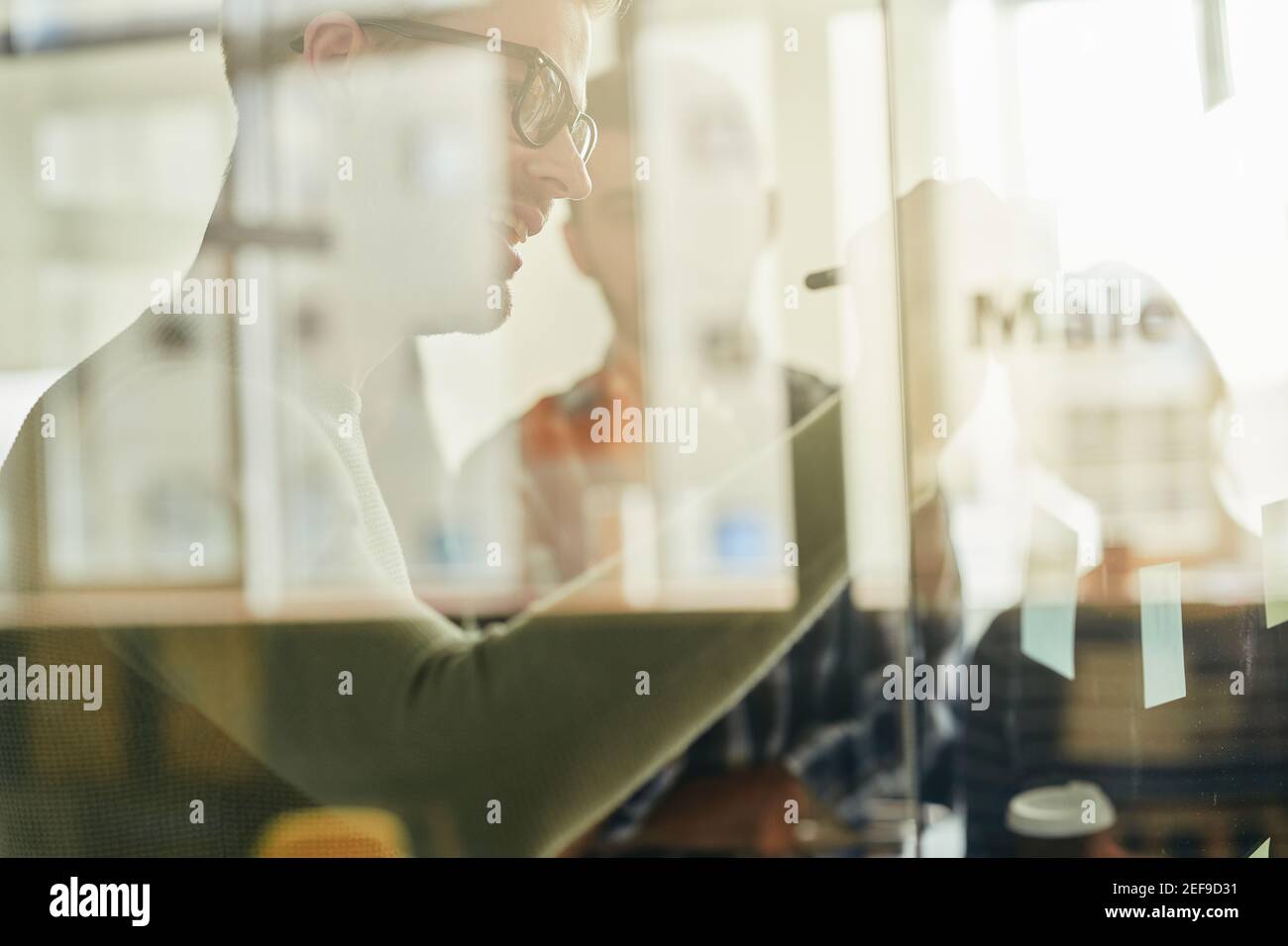 Abstract photo of smiley gentleman behind a glass window Stock Photo ...