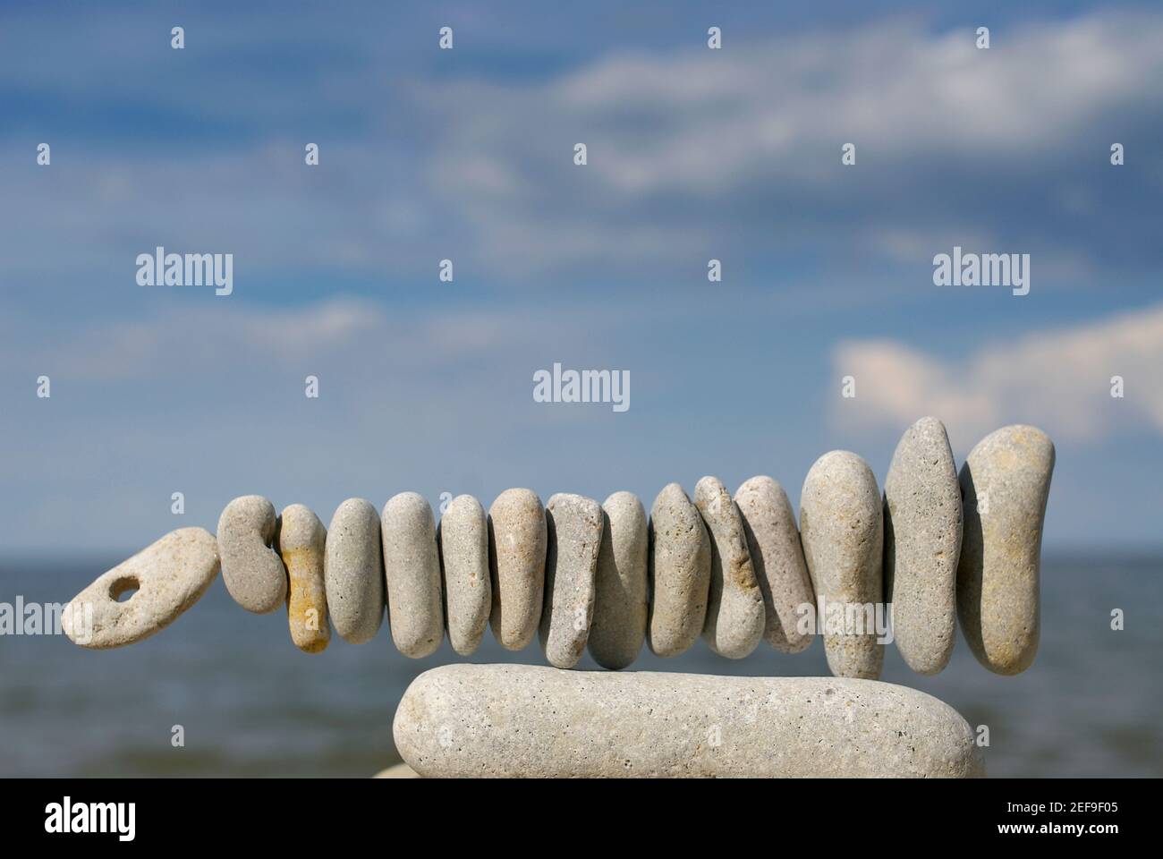 Balancing rocks in a row on the beach Stock Photo - Alamy