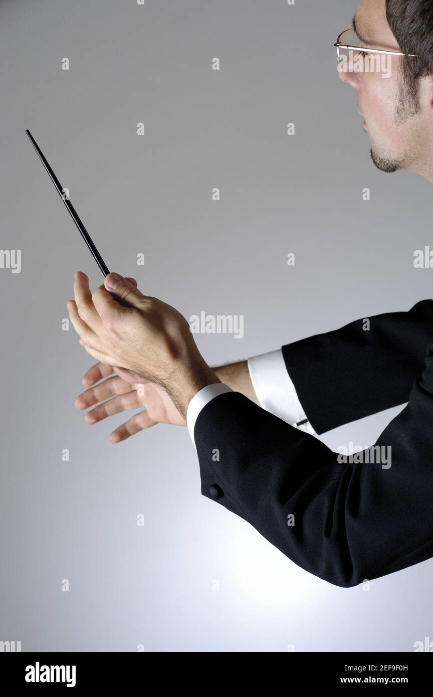 Human hand holding baton hi-res stock photography and images - Alamy