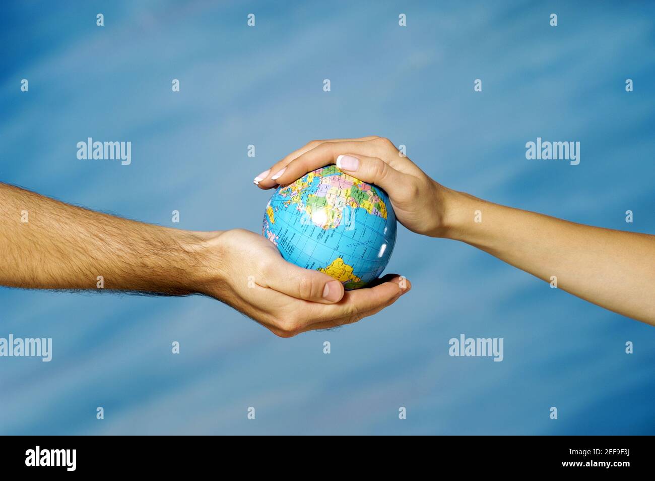 Two people holding up globe hi-res stock photography and images - Alamy