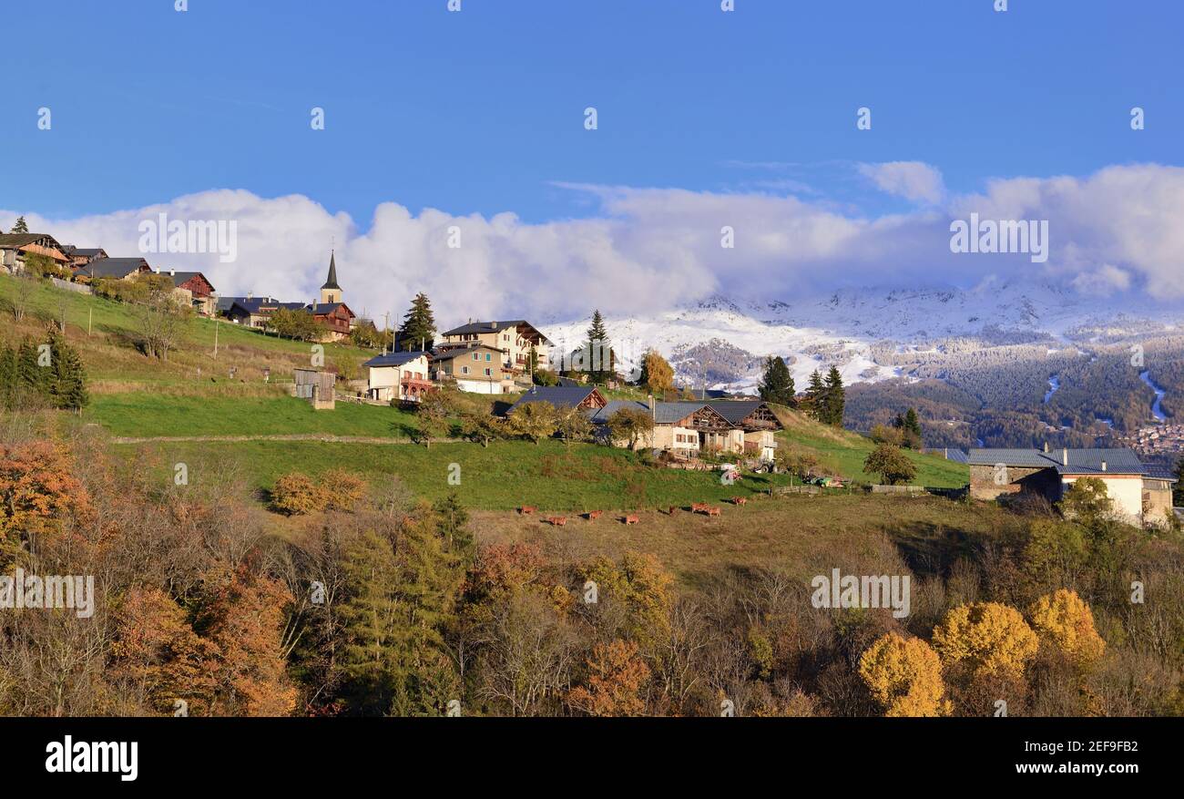 view on alpine village in a hill and snowy mountain background Stock ...