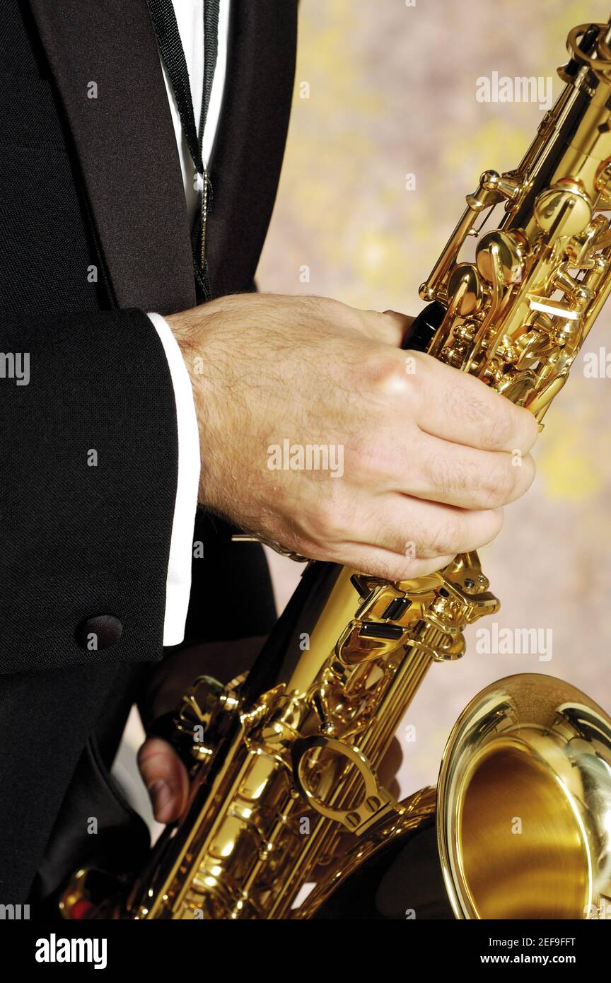 Mid section view of a musician playing the saxophone Stock Photo - Alamy