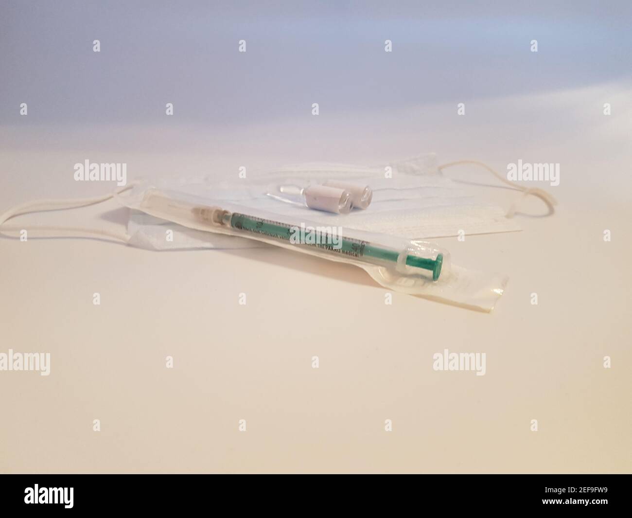 Vial vaccine, glass ampoules and a syringe with medical protective mask ...