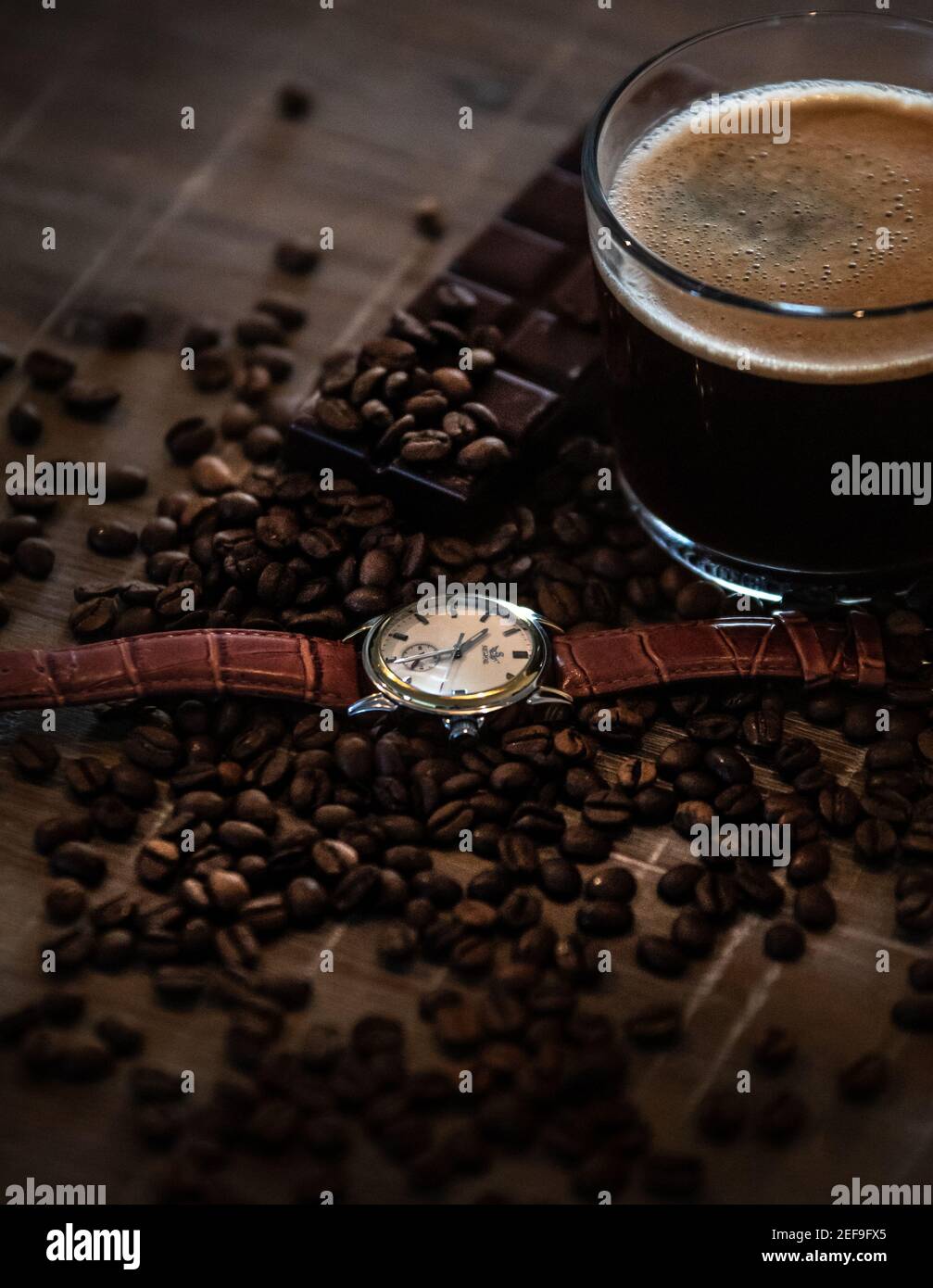 coffee, chocolate, beans and a watch Stock Photo - Alamy