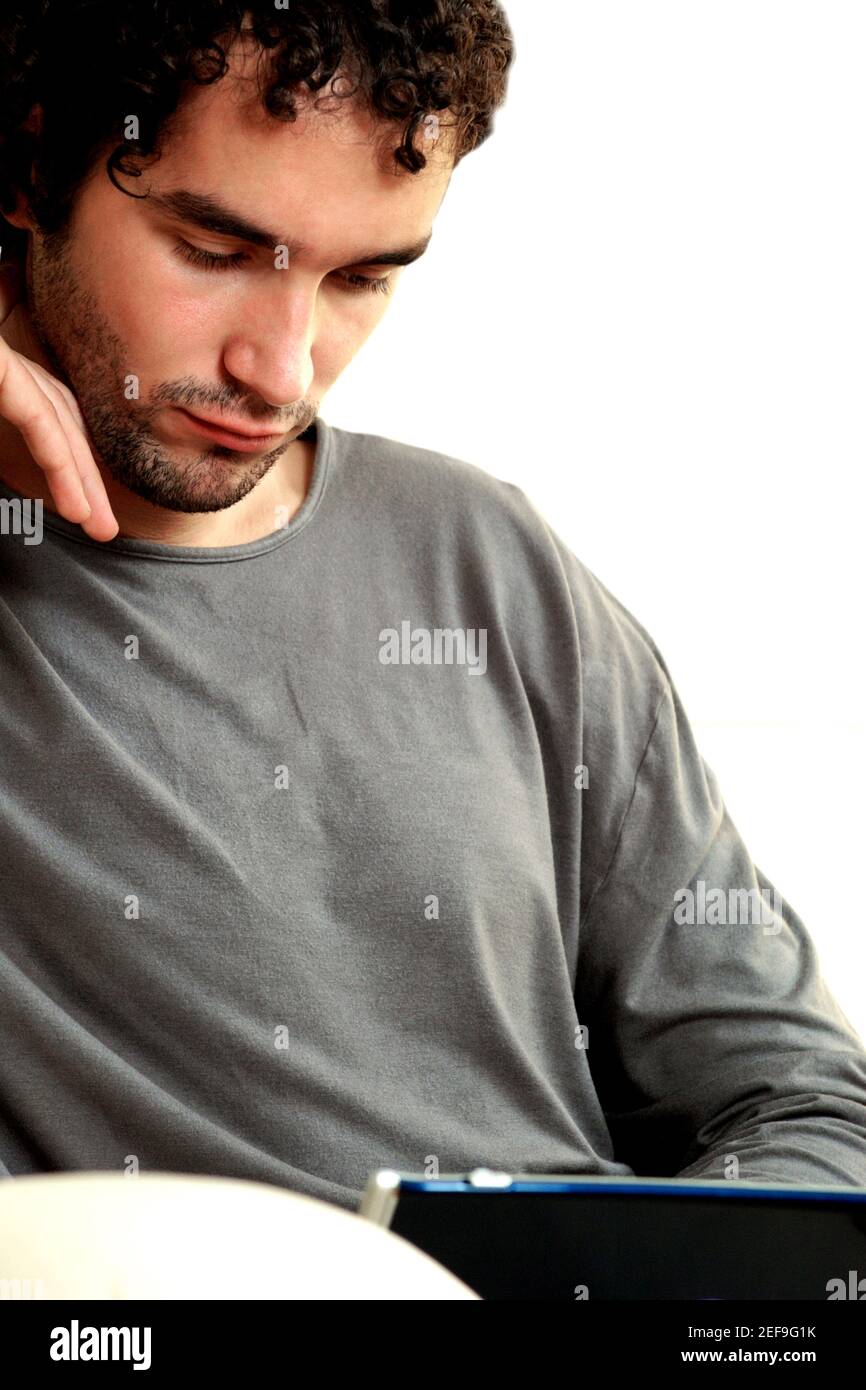Close-up of a young man looking down Stock Photo - Alamy