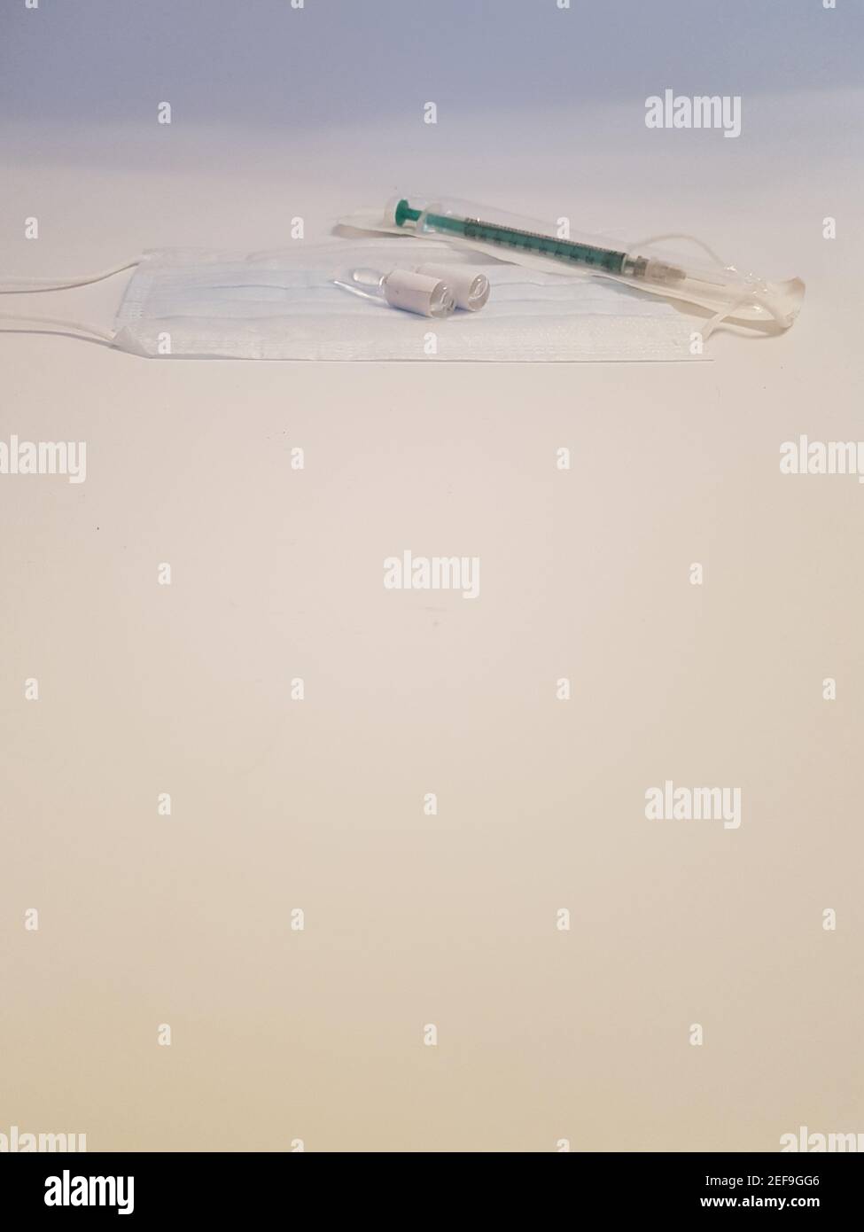 Vial vaccine, glass ampoules and a syringe with medical protective mask ...