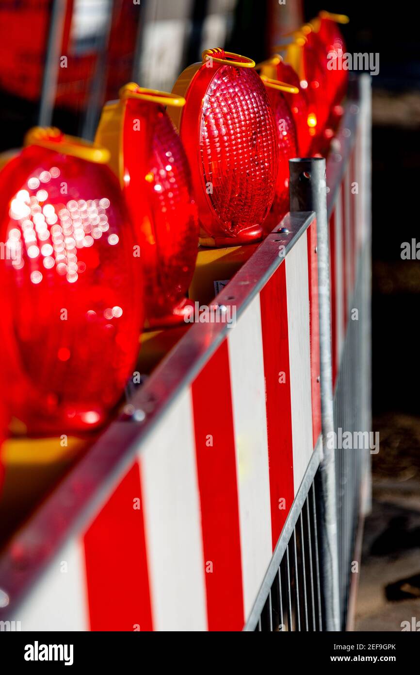 Close-up of red warning lights with street barriers Stock Photo - Alamy