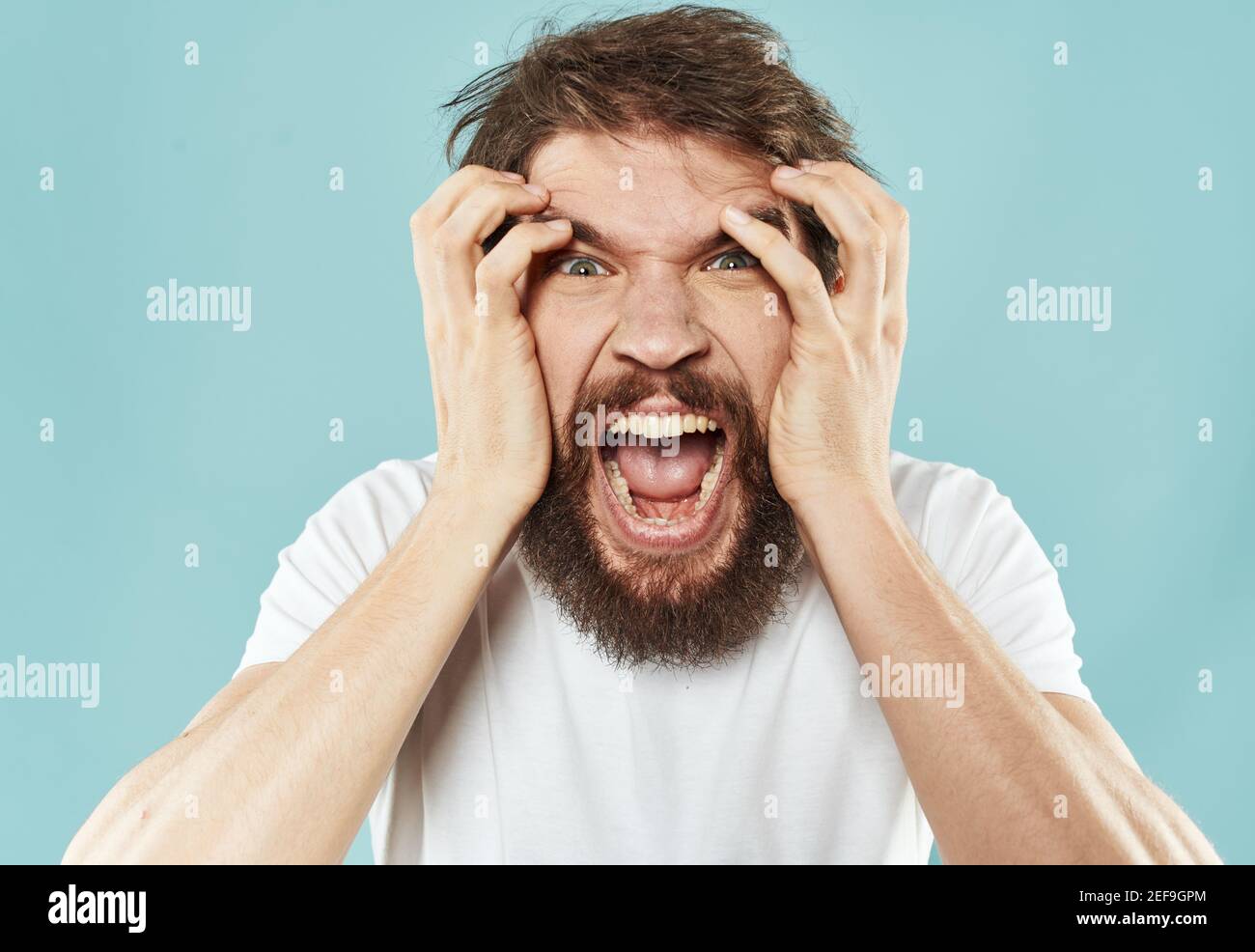aggressive man yelling on blue background stress irritability emotions ...