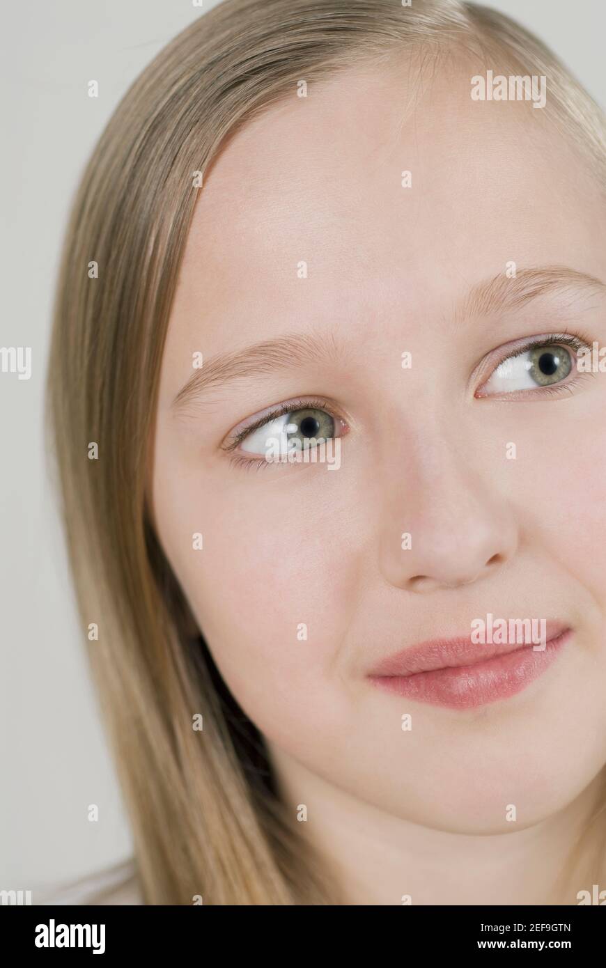 Close up of a girl thinking and looking sideways Stock Photo - Alamy