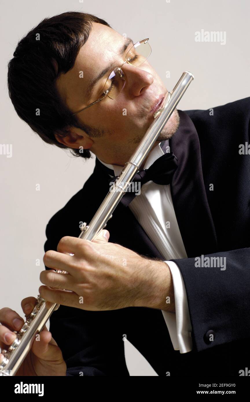 Young man playing flute instrument hi-res stock photography and images ...