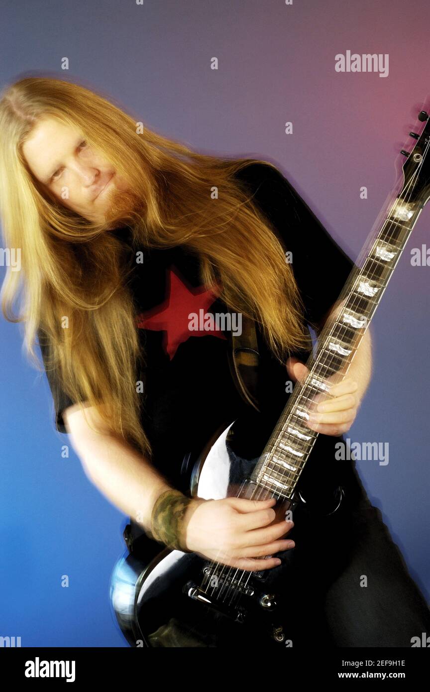 Portrait of a musician playing the electric guitar Stock Photo - Alamy