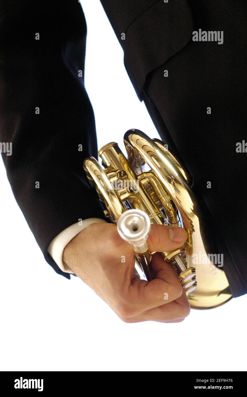 Mid section view of a musician holding a trumpet Stock Photo - Alamy